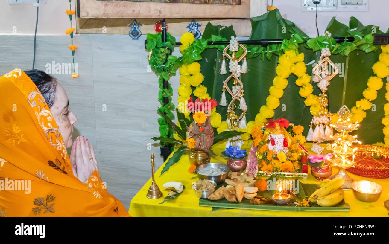 devotee worship to holy hindu god ganesha idol with holy offering at ...