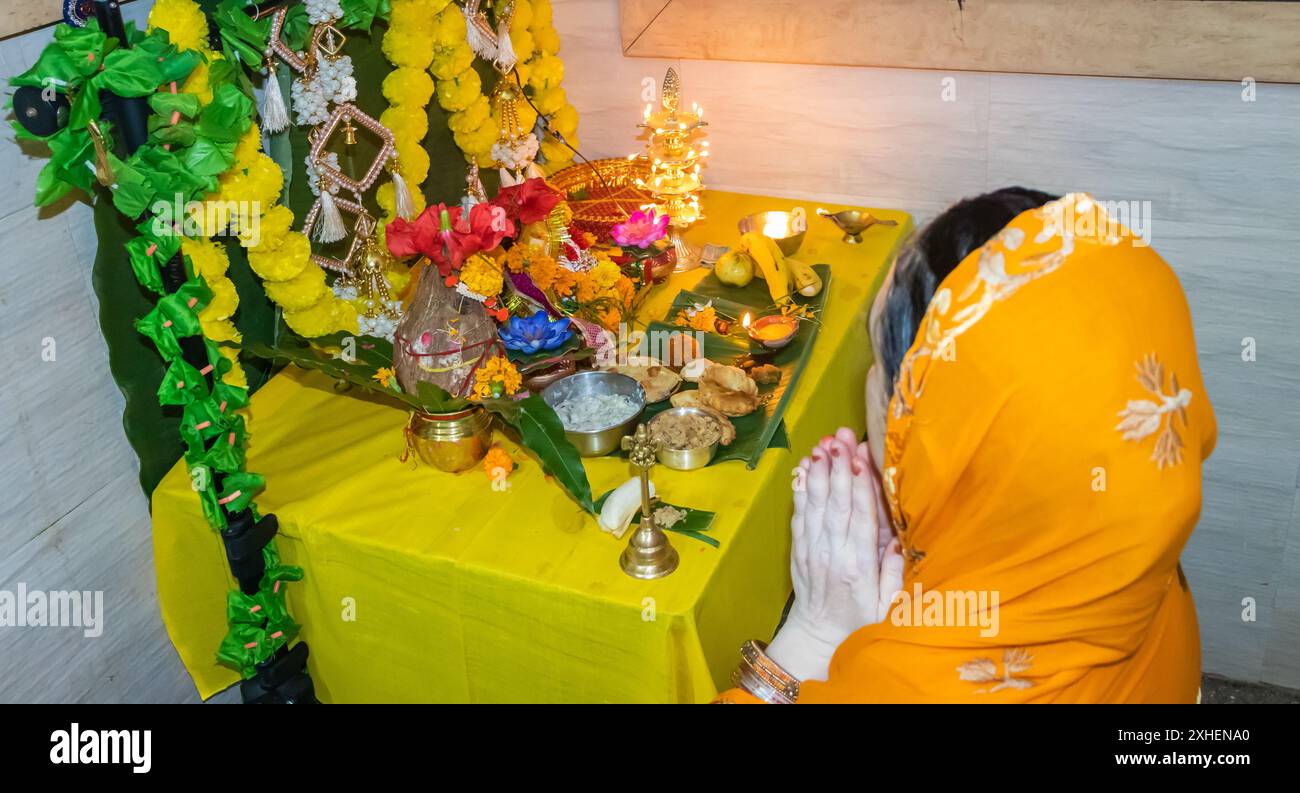 devotee worship to holy hindu god ganesha idol with holy offering at ...