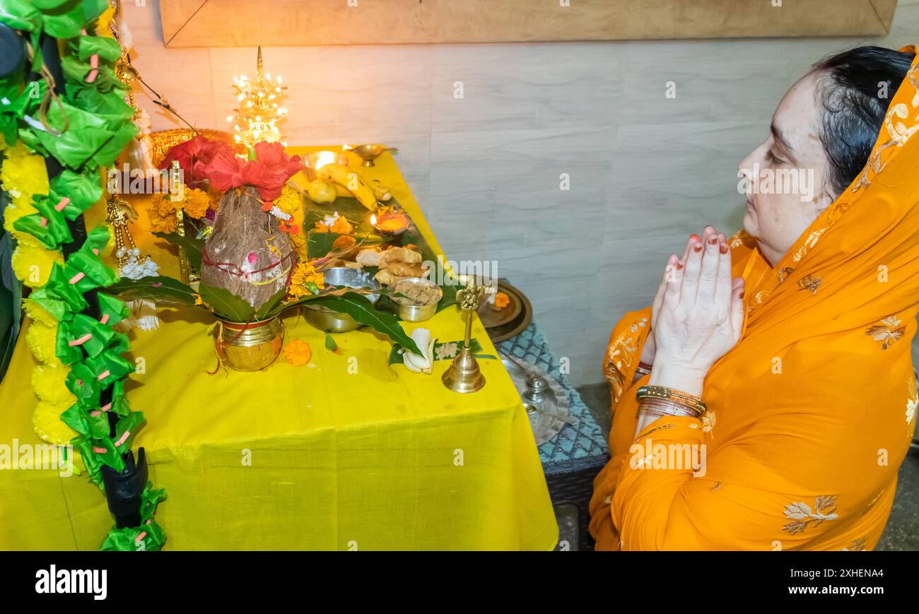devotee worship to holy hindu god ganesha idol with holy offering at ...