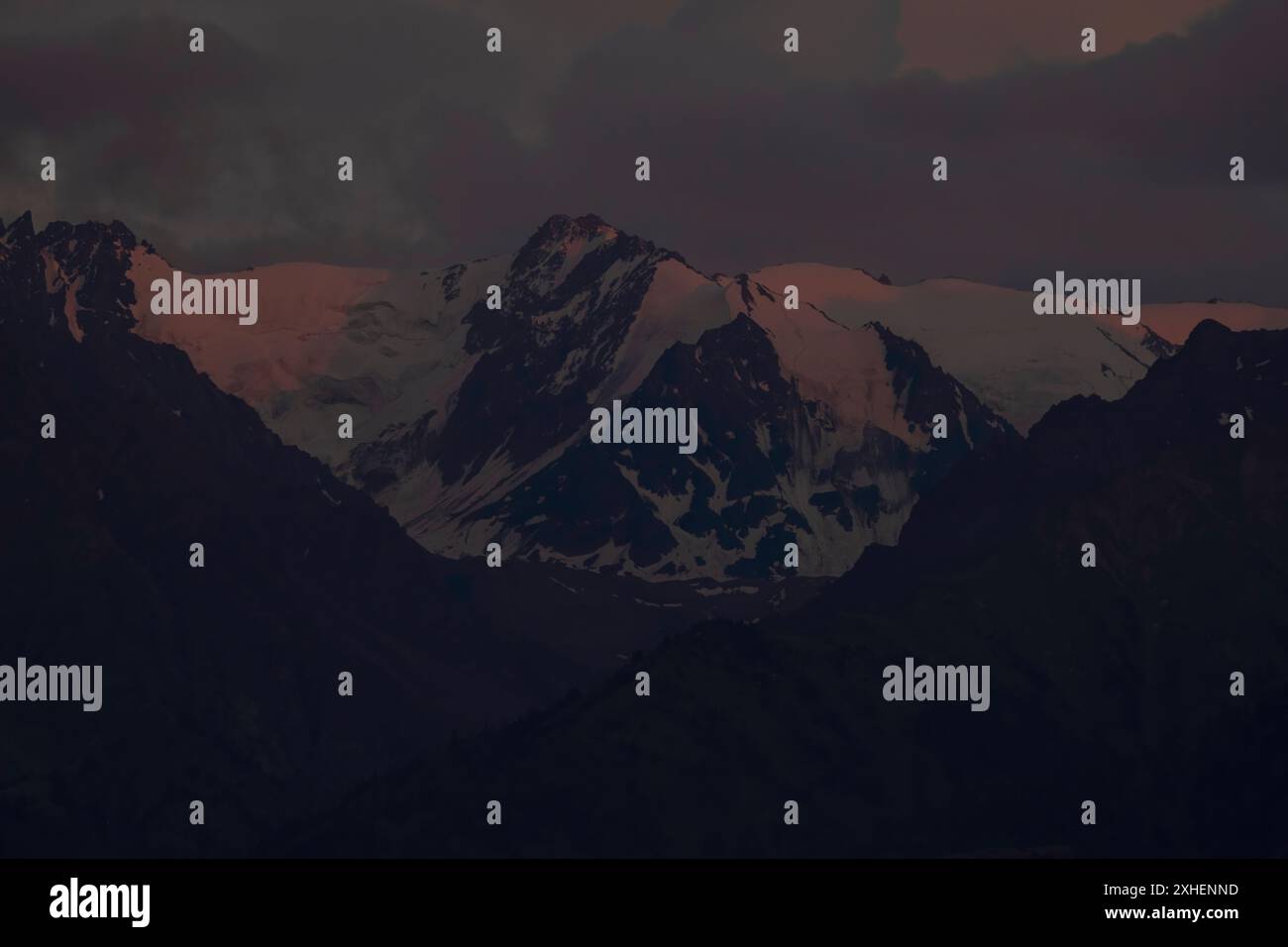 Beautiful harsh mountains and glaciers at sunset in the city of Almaty ...