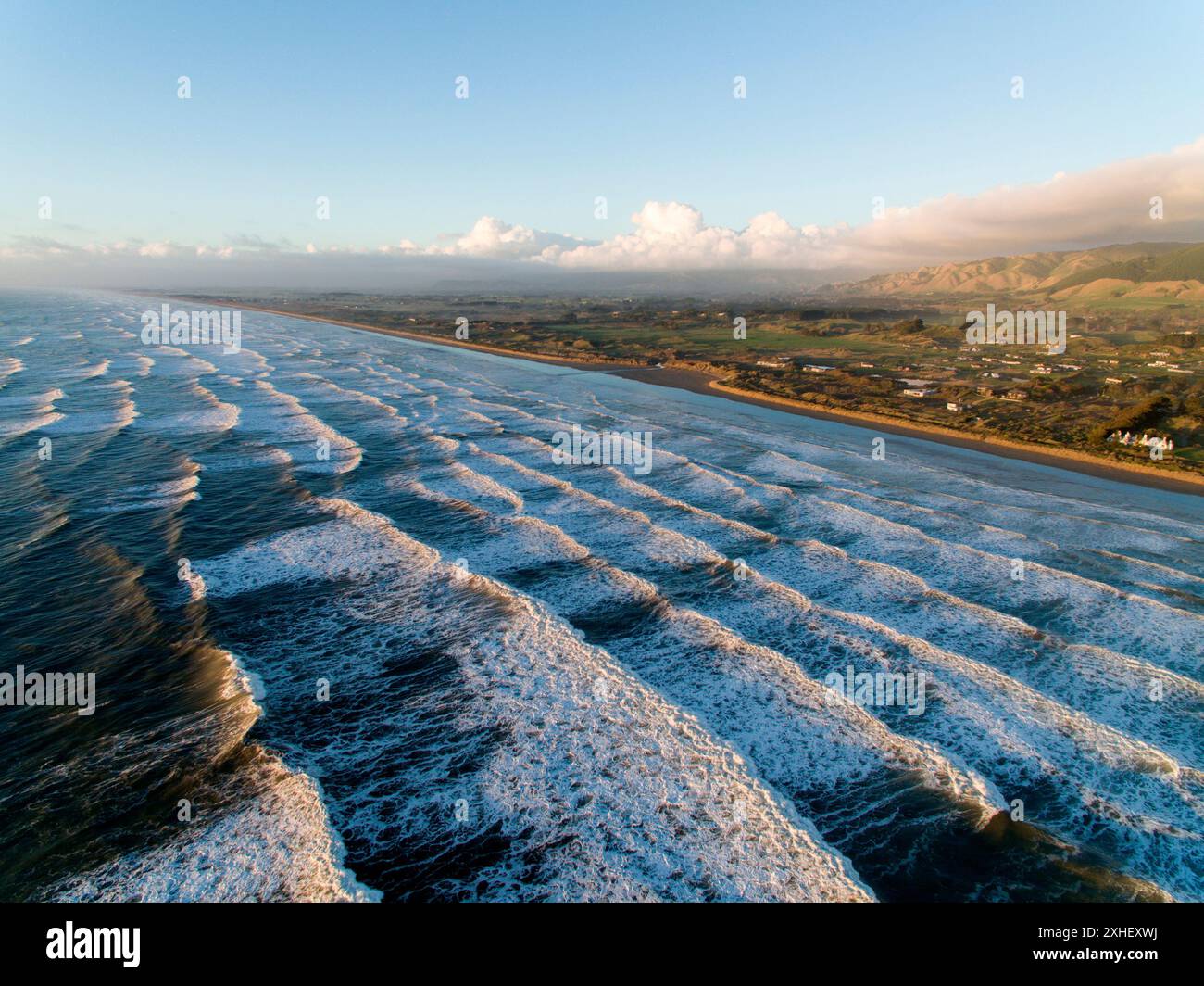 Aerial view of large waves breaking along coastline at Peka Peka beach, Kapiti, New Zealand ...