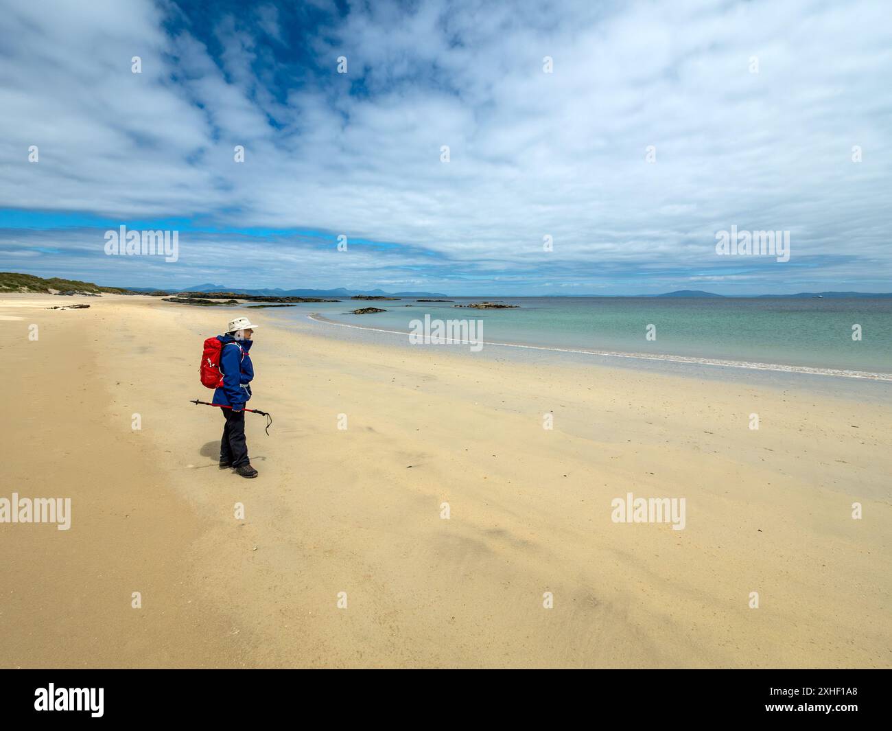 Female tourist / holidaymaker / walker / looking at the beautiful sands ...