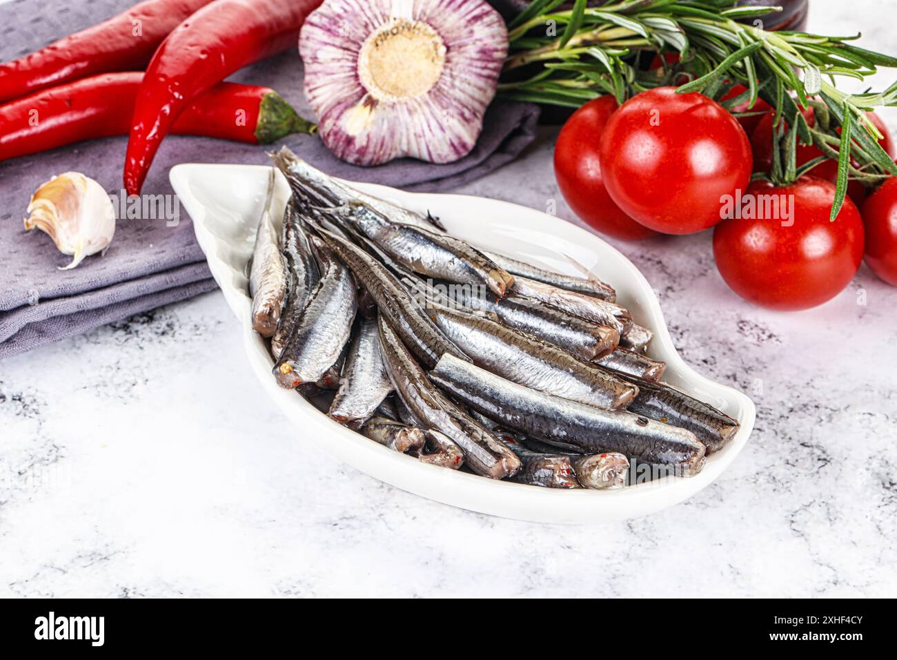 Pickled anchovy fish in the plate Stock Photo - Alamy
