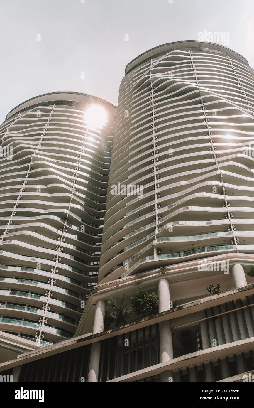 Bottom-up of tall skyscraper covered reflective panels sun rays are ...