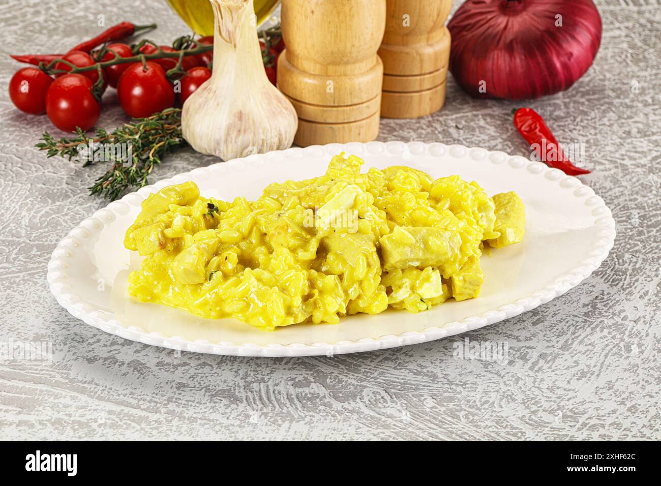 Italian cuisine - yellow risotto with chicken and soft cheese Stock ...