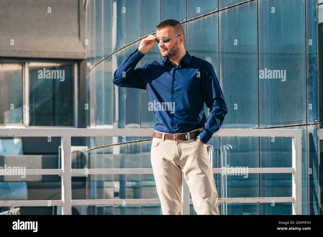 Standing looking out balcony hi-res stock photography and images - Alamy