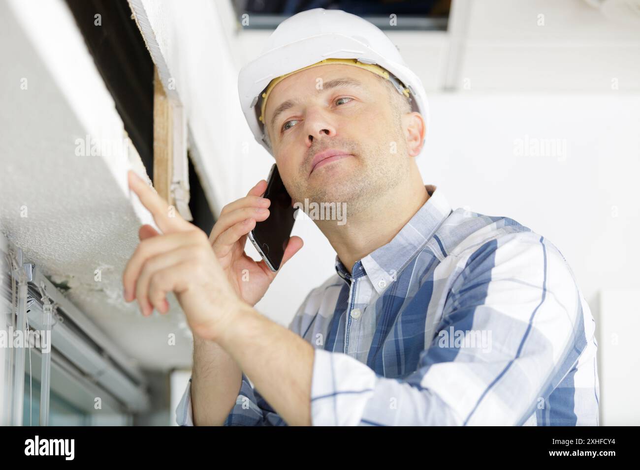 professional builder with safety helmet having a phone call Stock Photo ...