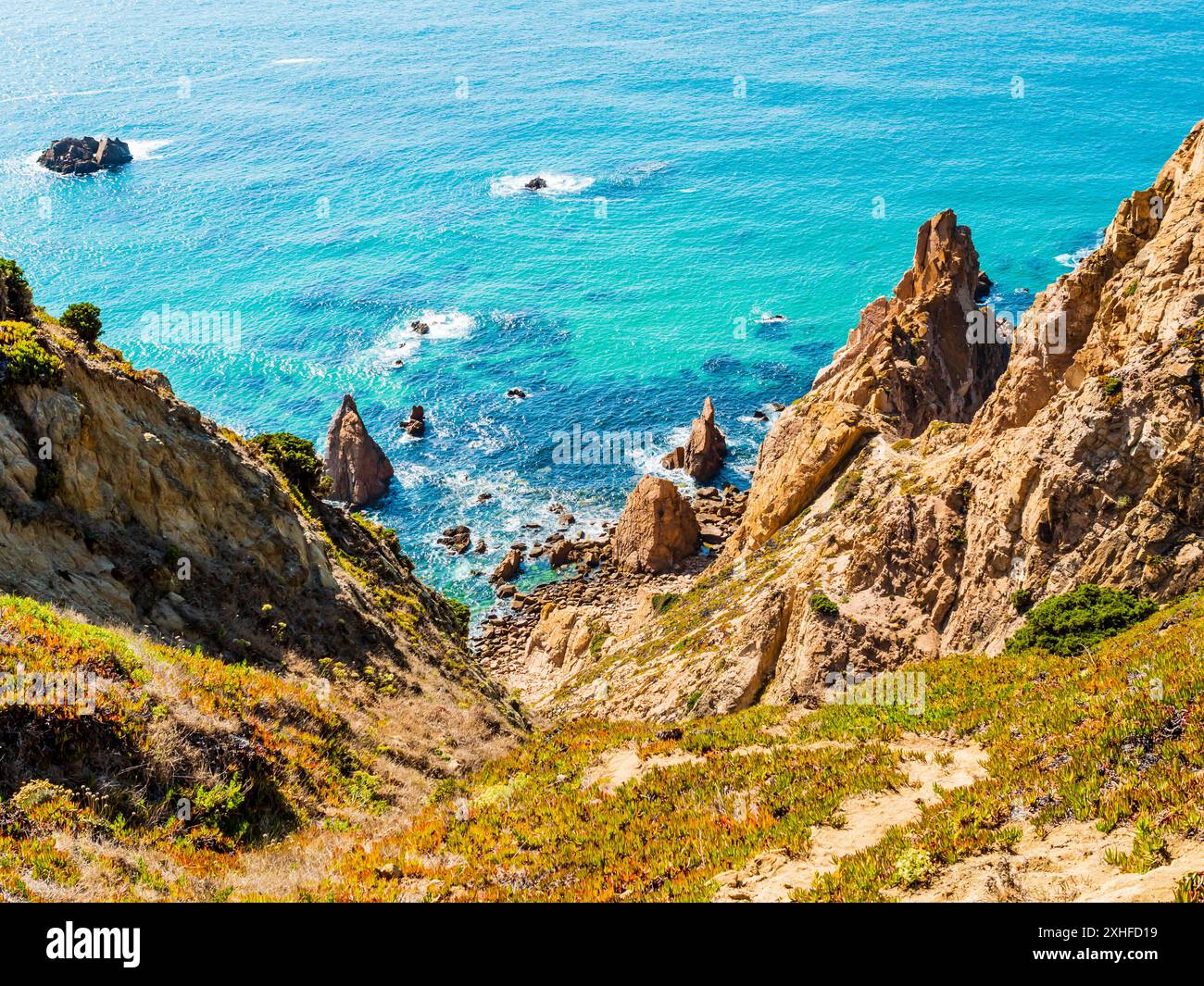 Impressive steep cliffs and emerald sea in Ursa beach (praia da ursa ...