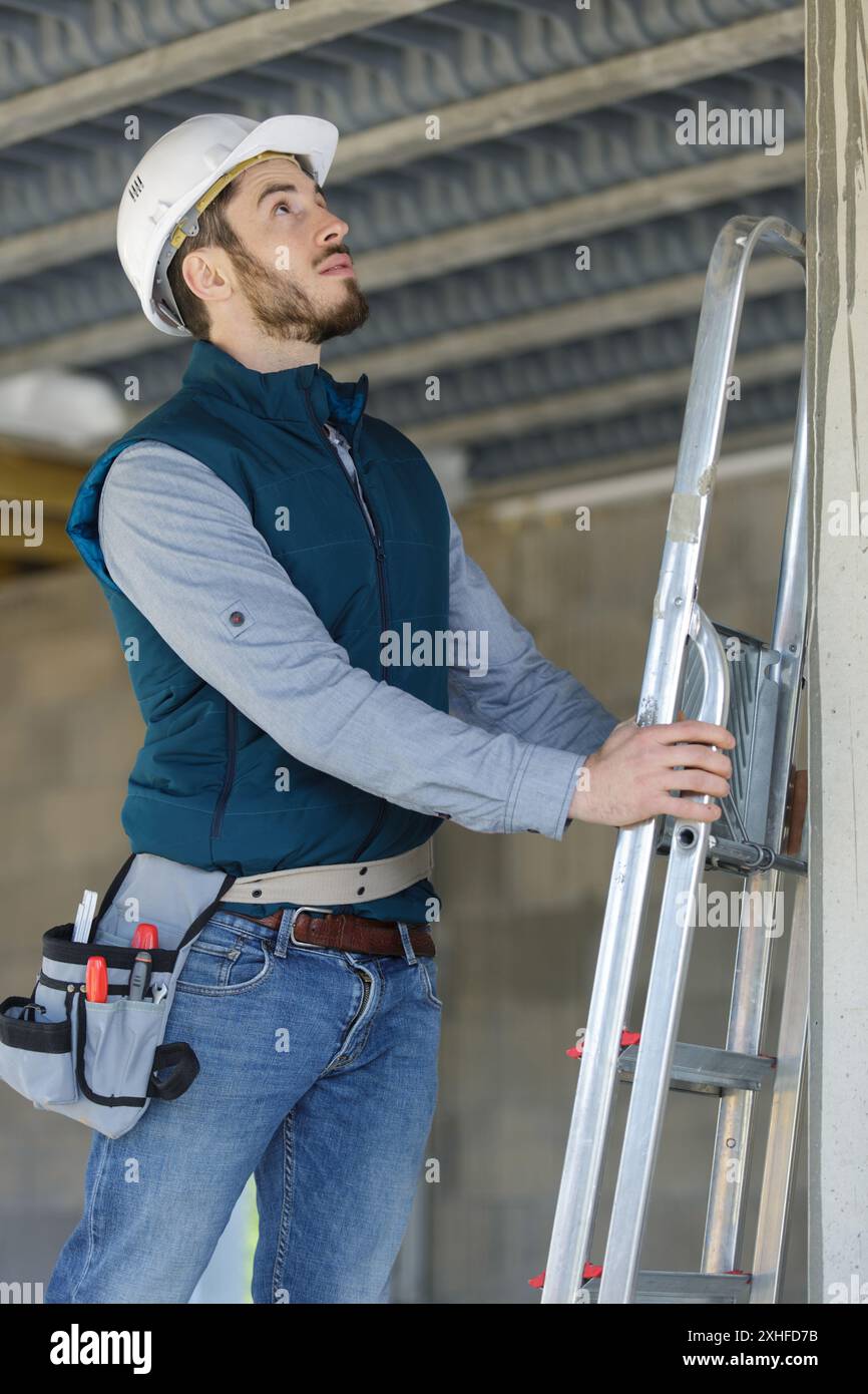 male builder on ladder Stock Photo - Alamy
