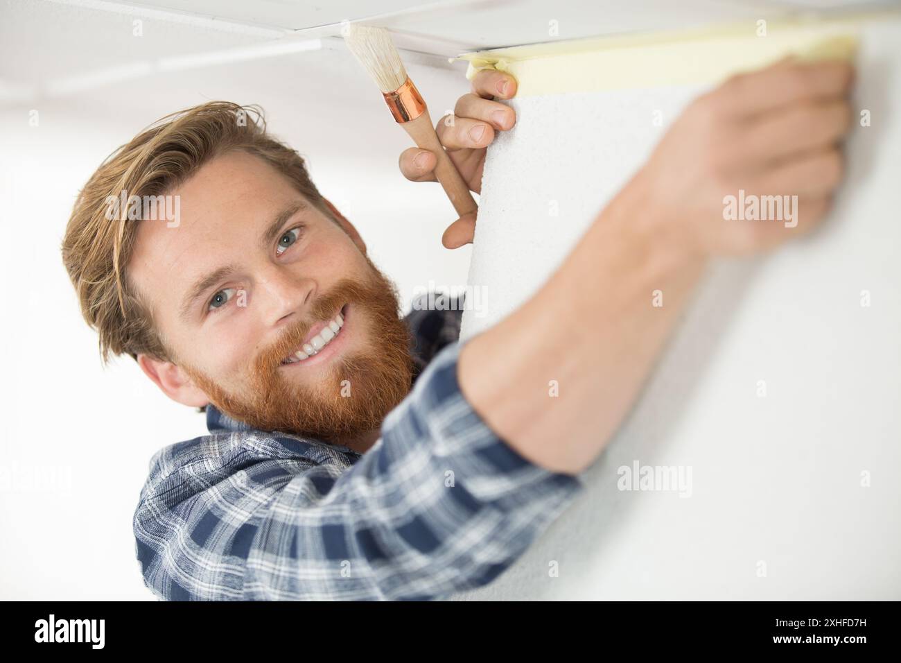 man painting ceiling with white color Stock Photo - Alamy