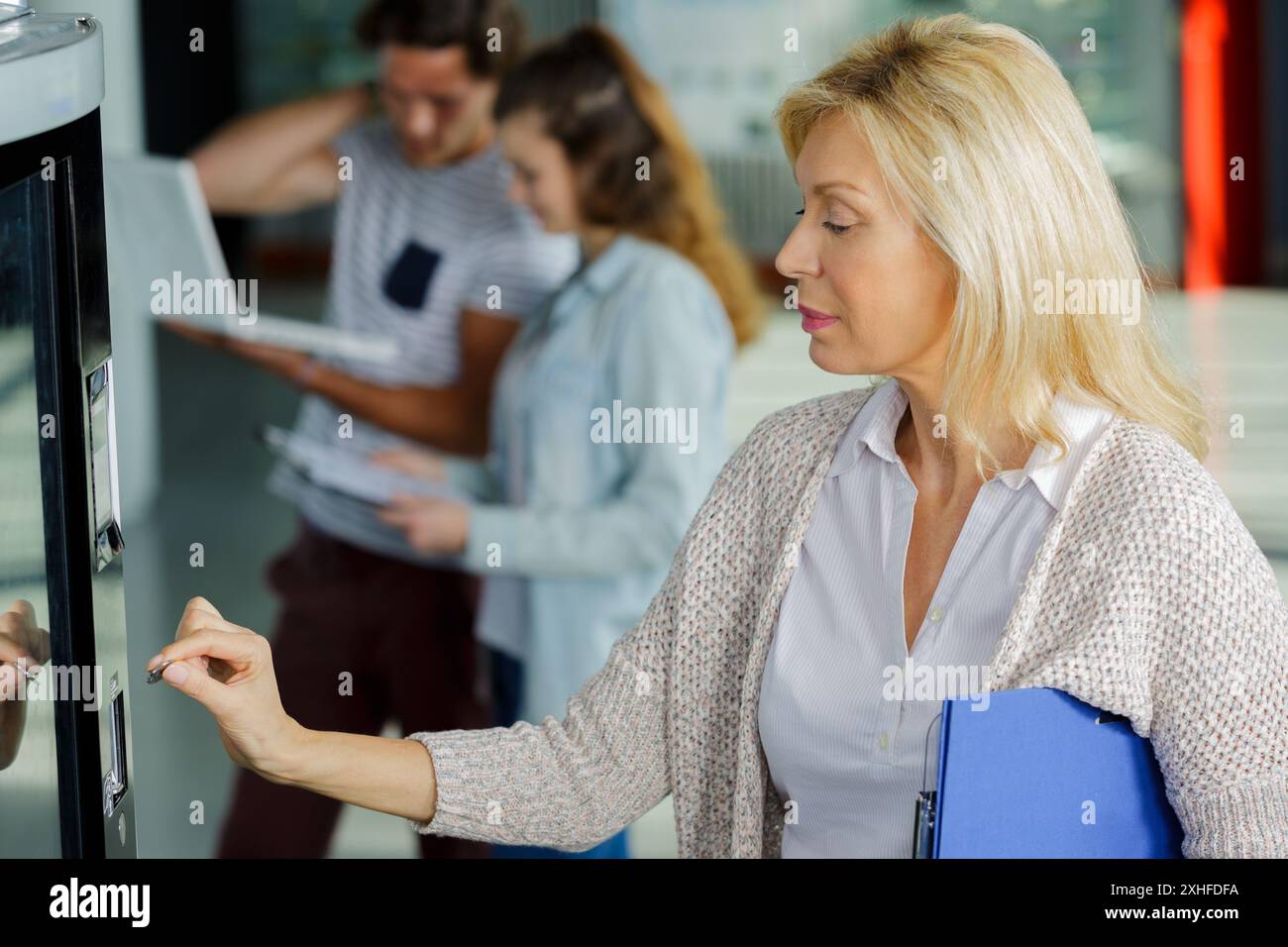 woman pushing button on vending machine Stock Photo - Alamy