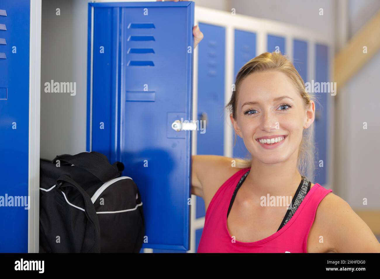 portrait of beautiful woman at her locker in sports center Stock Photo - Alamy
