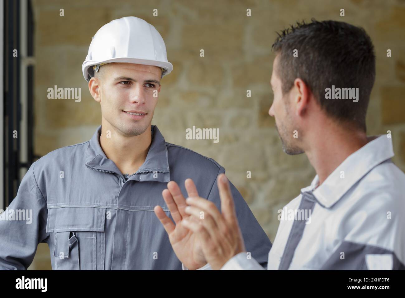 construction workers talking in construction site Stock Photo - Alamy