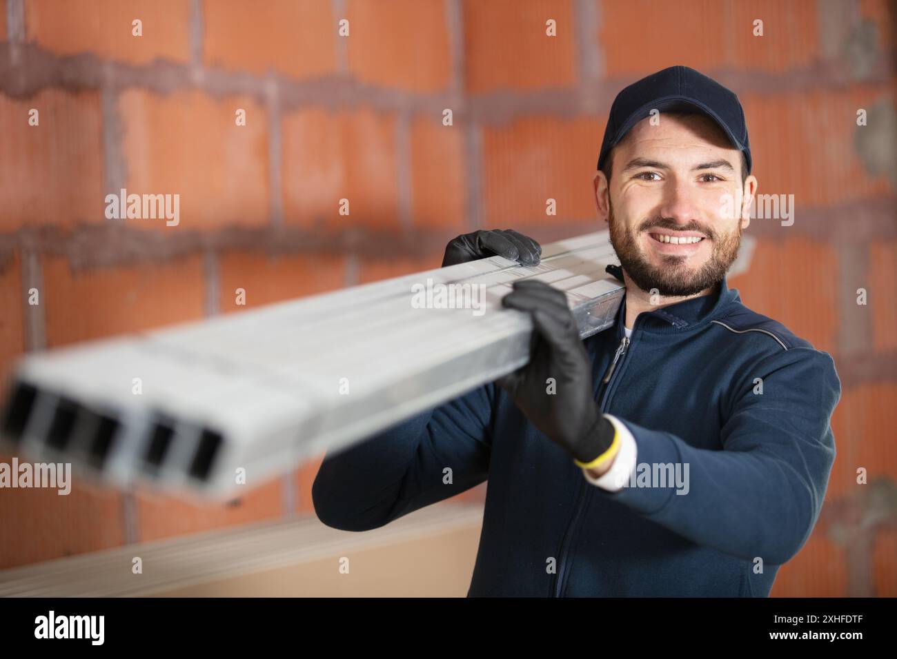 construction worker carrying reinforcement rods at building site Stock ...