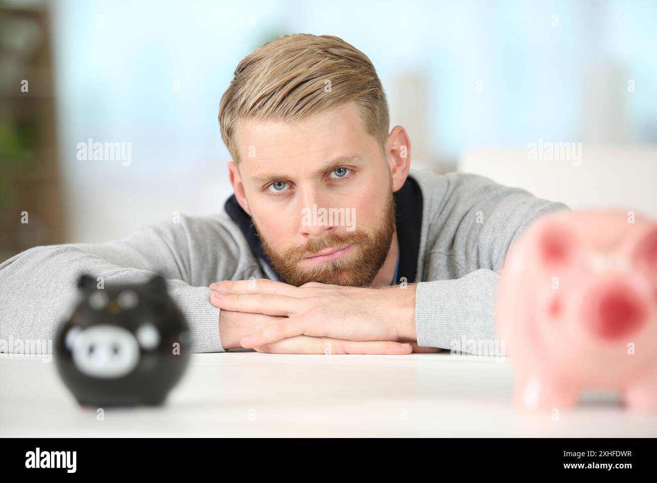 Worried business man money piggy hi-res stock photography and images ...
