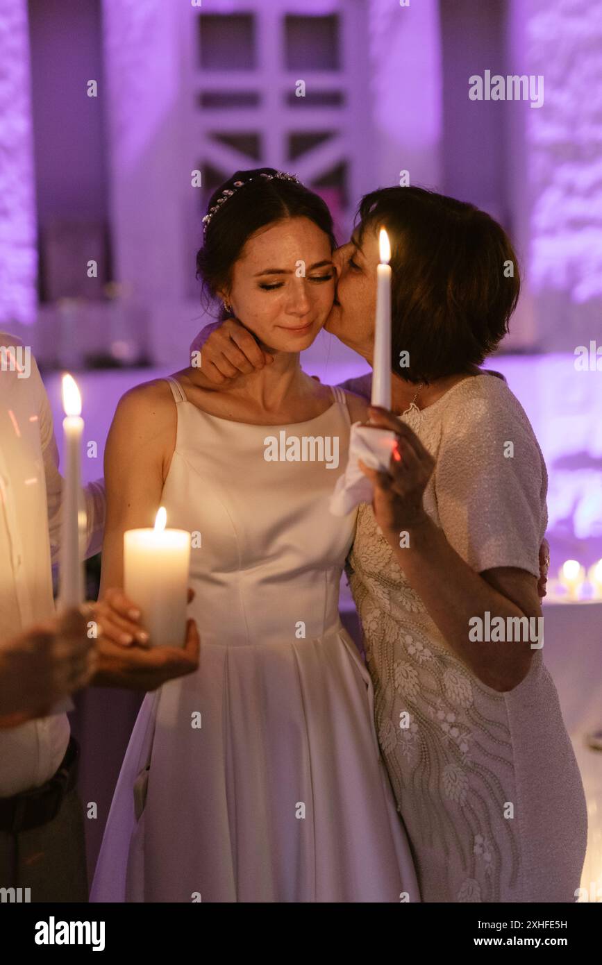 transfer of wedding fire with the help of candles from mothers to the newlyweds Stock Photo - Alamy