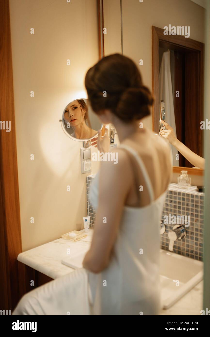 bride in a veil with makeup paints her lips in the bathroom Stock Photo ...