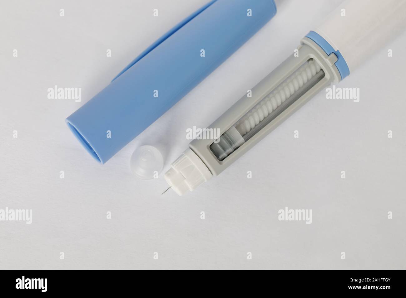 Self injection pen macro. Blue injection pen close up top view ...