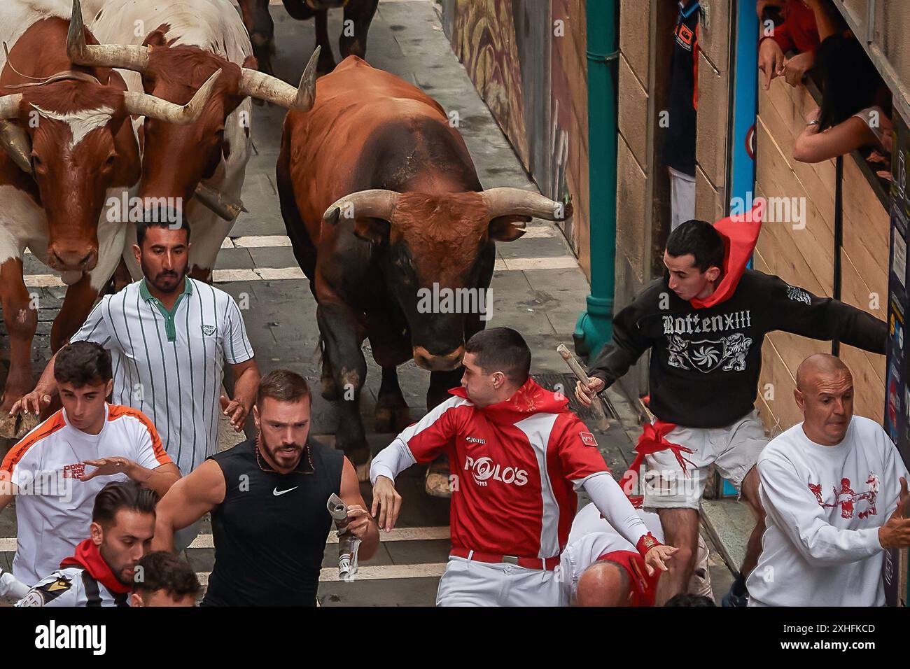 Several "mozos" run in front of the bulls of the Miura ranch in the ...