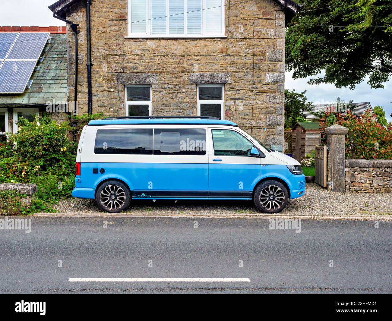 Arnside Cumbria UK. A blue and white VW camper van parked beside a ...