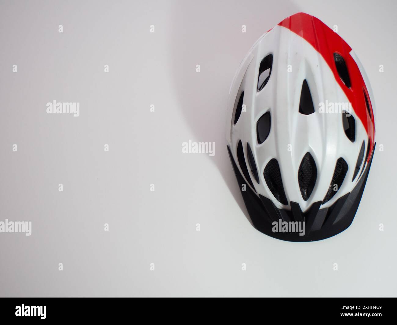 A white and red bicycle helmet on a plain white background Stock Photo ...