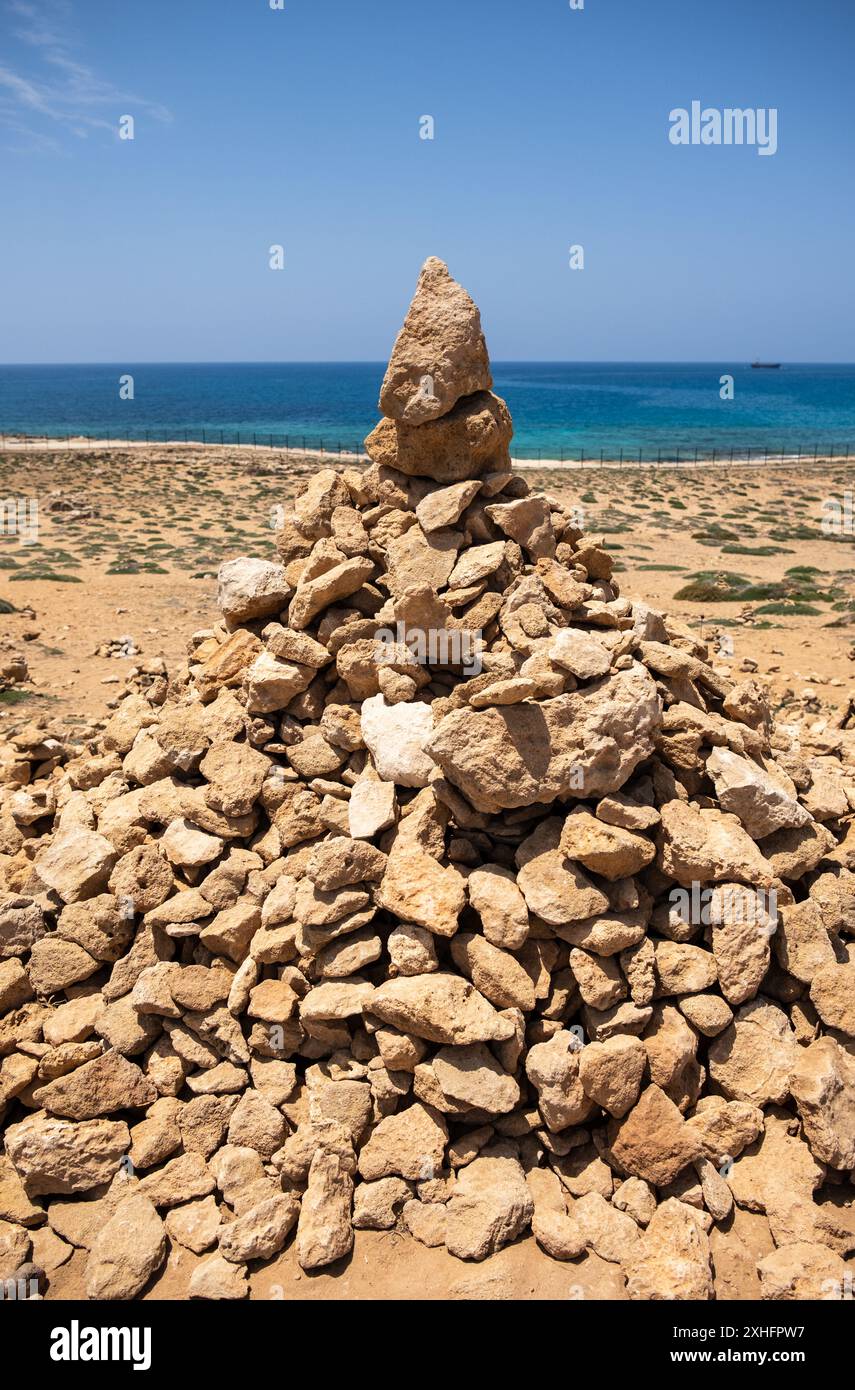 Stacked pebble stones " cairns " on the beach close to the " Tombs of ...