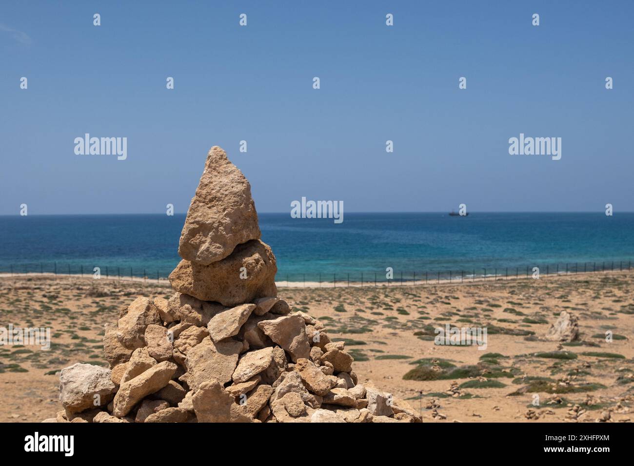Stacked pebble stones " cairns " on the beach close to the " Tombs of ...