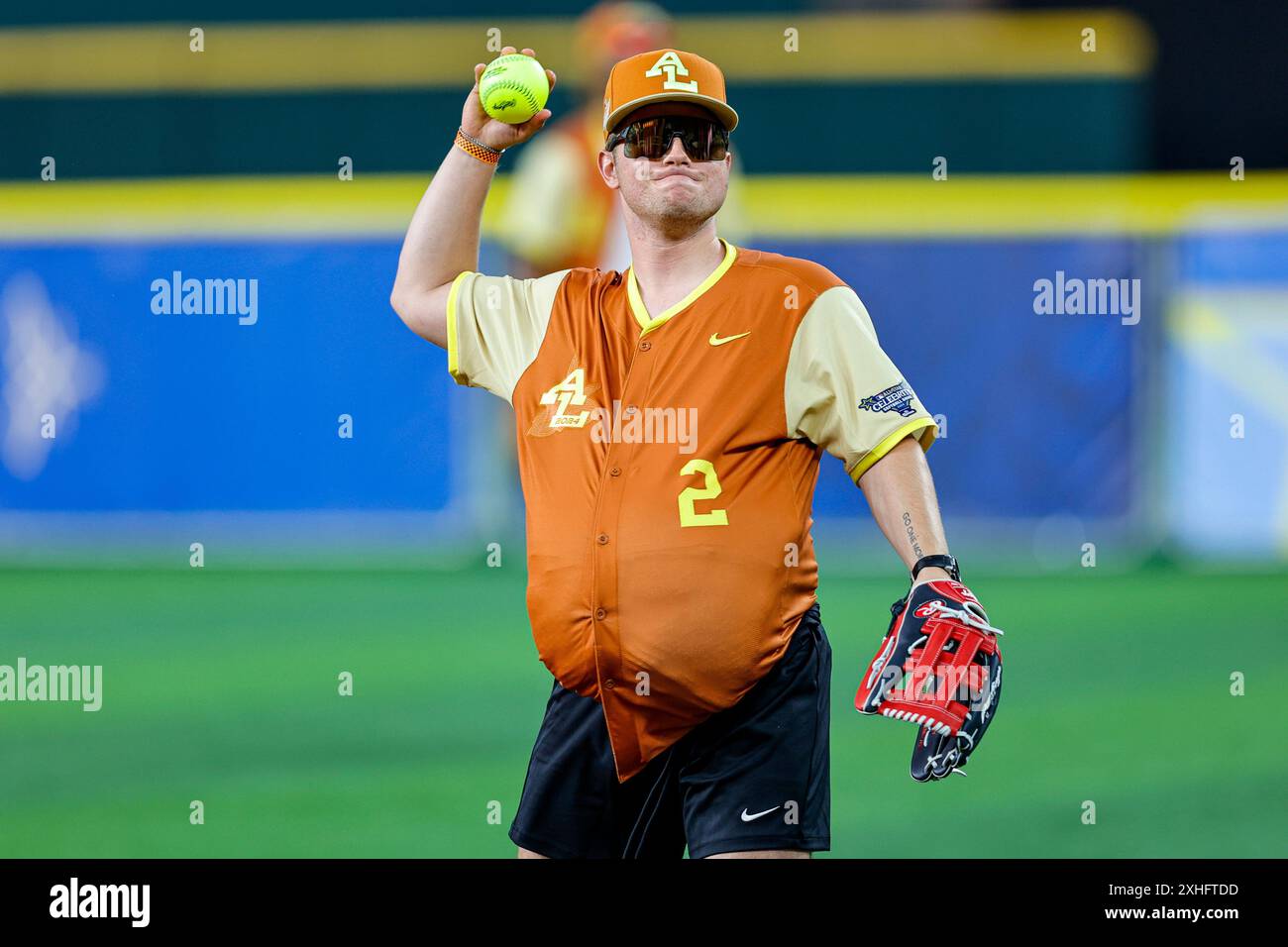 American League manager Nick Cass (2) warms up before the All-Star Celebrity Softball Game ...