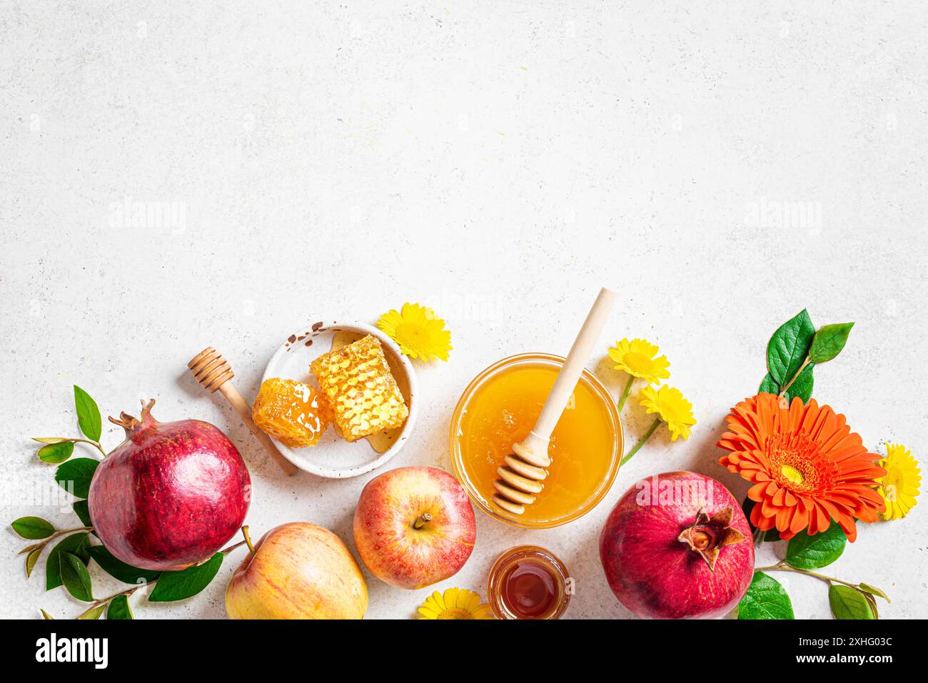 Rosh Hashanah. Pomegranate, apples and honey traditional symbos for celebration on white ...