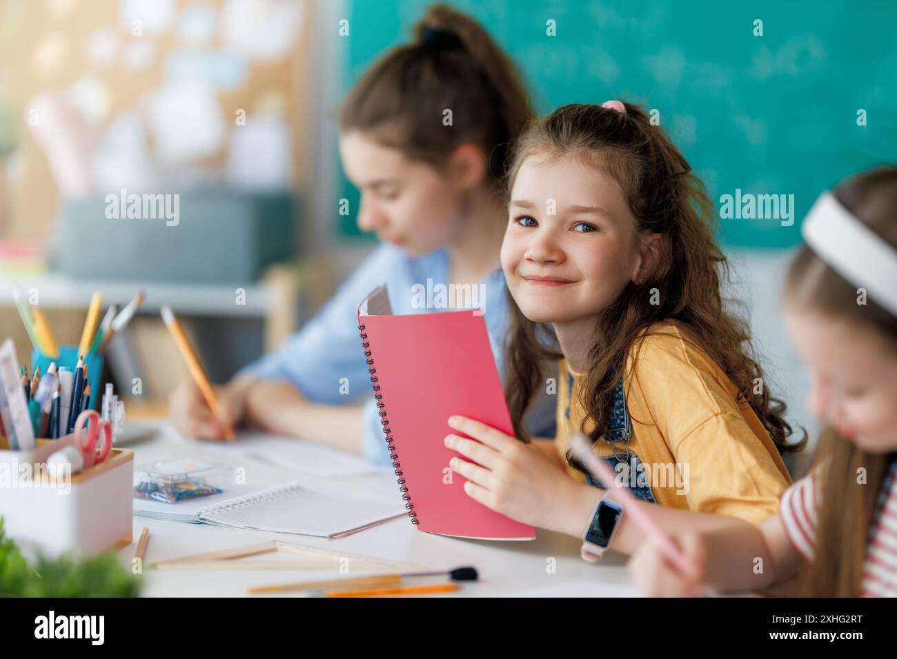 Happy kids at school. Children are learning in the class Stock Photo ...