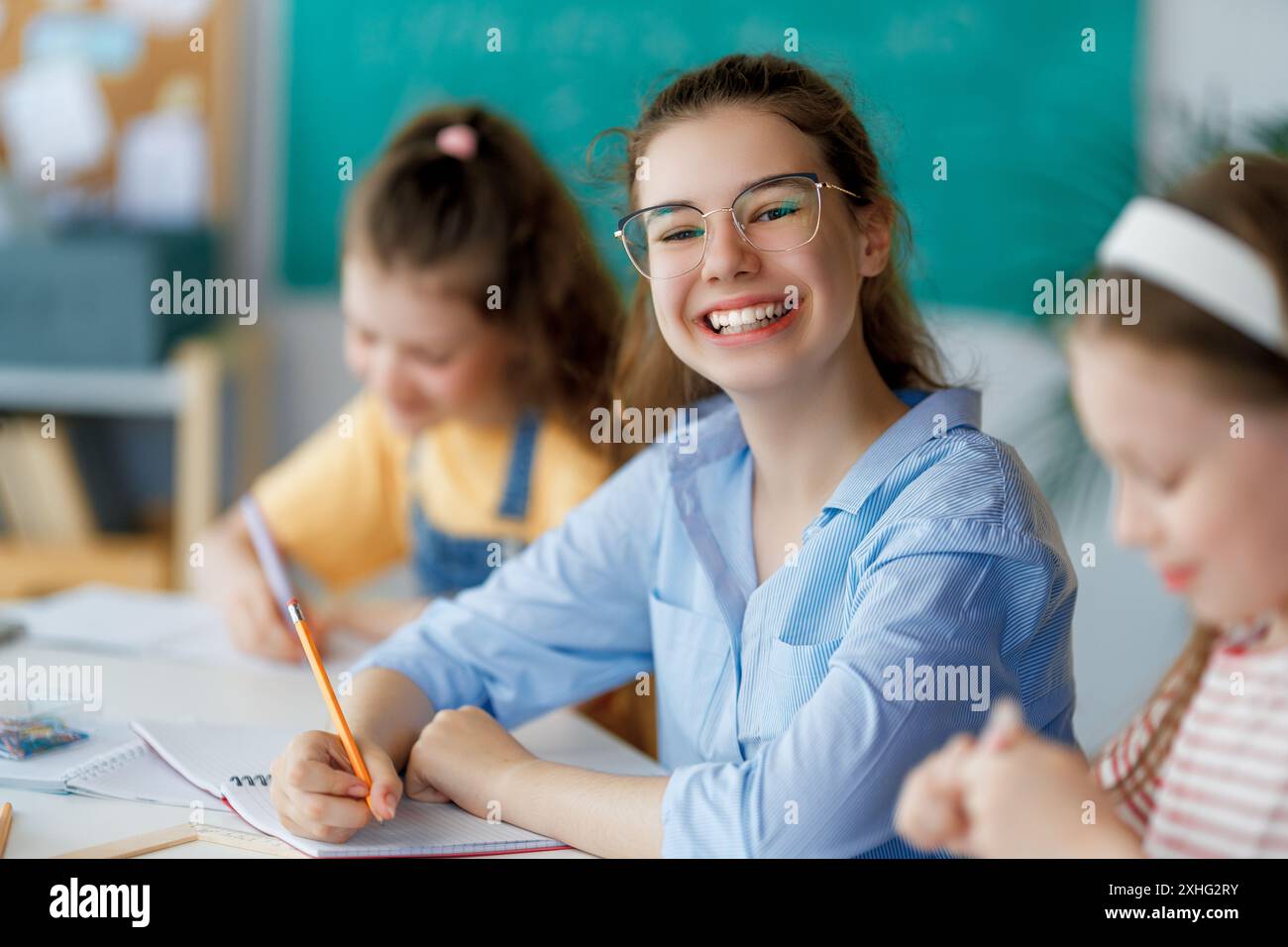 Happy kids at school. Children are learning in the class Stock Photo ...