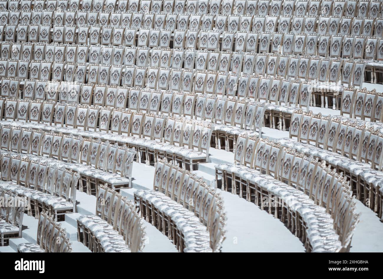 A detailed view of rows of intricately designed chairs arranged in a ...