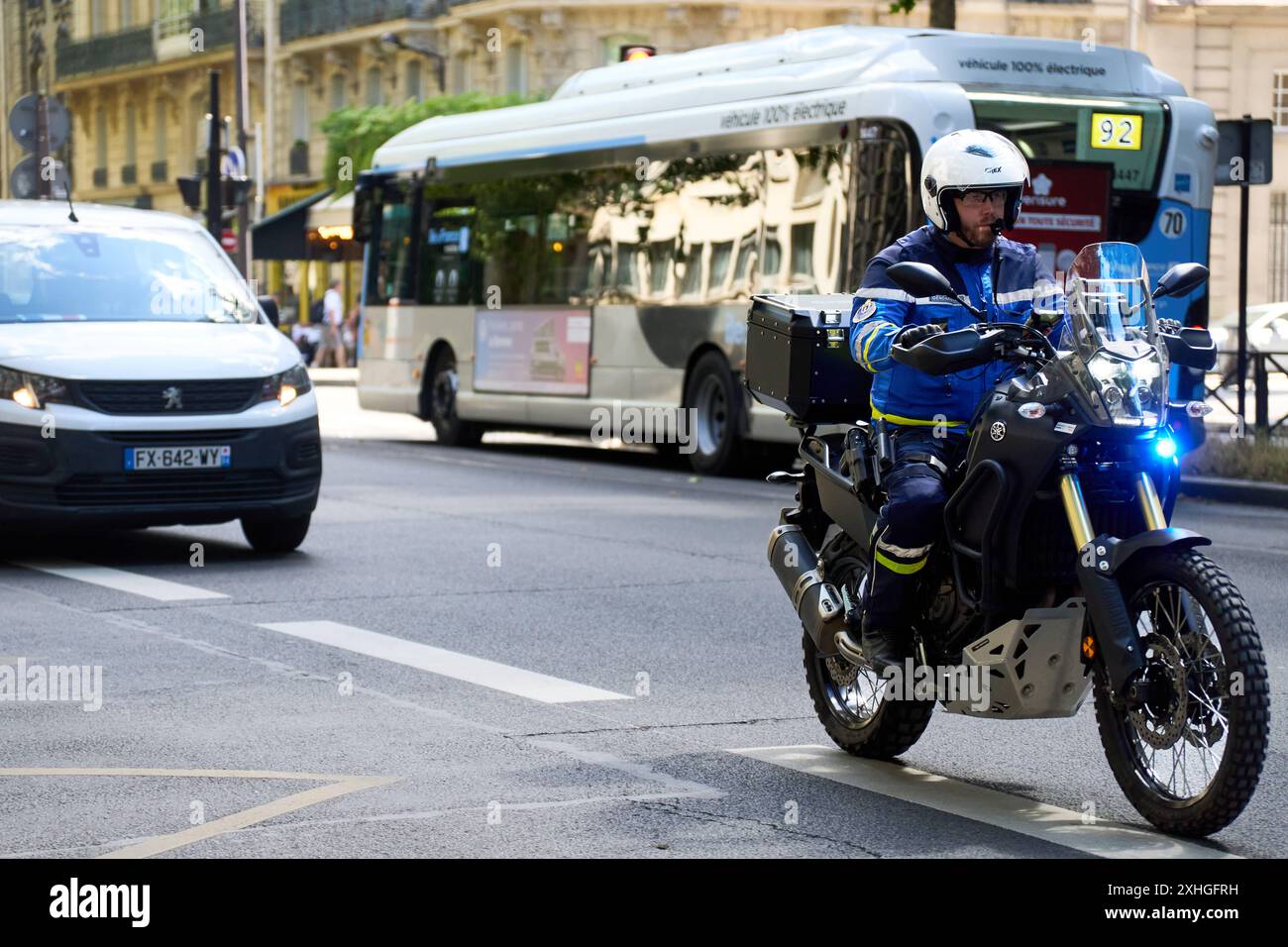 Paris, France - July 13, 2024: A French police officer with blue lights ...