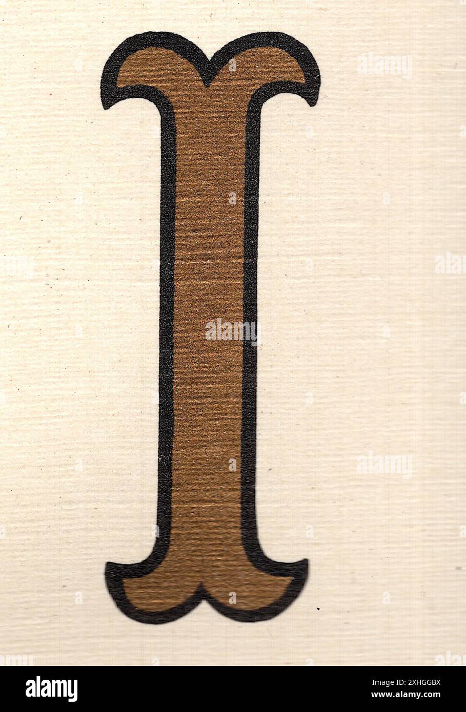 A decorative antique capital letter I in gold with a black outline on a ...