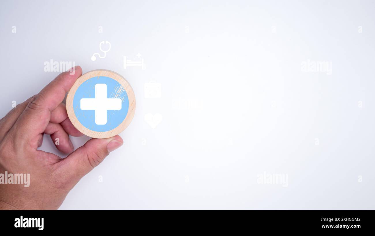 Human hand holding a plus sign and healthcare medical icon on white ...