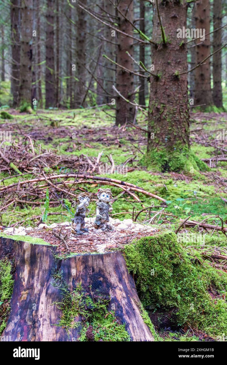 Troll figures stand on a tree stump in the forest Stock Photo - Alamy