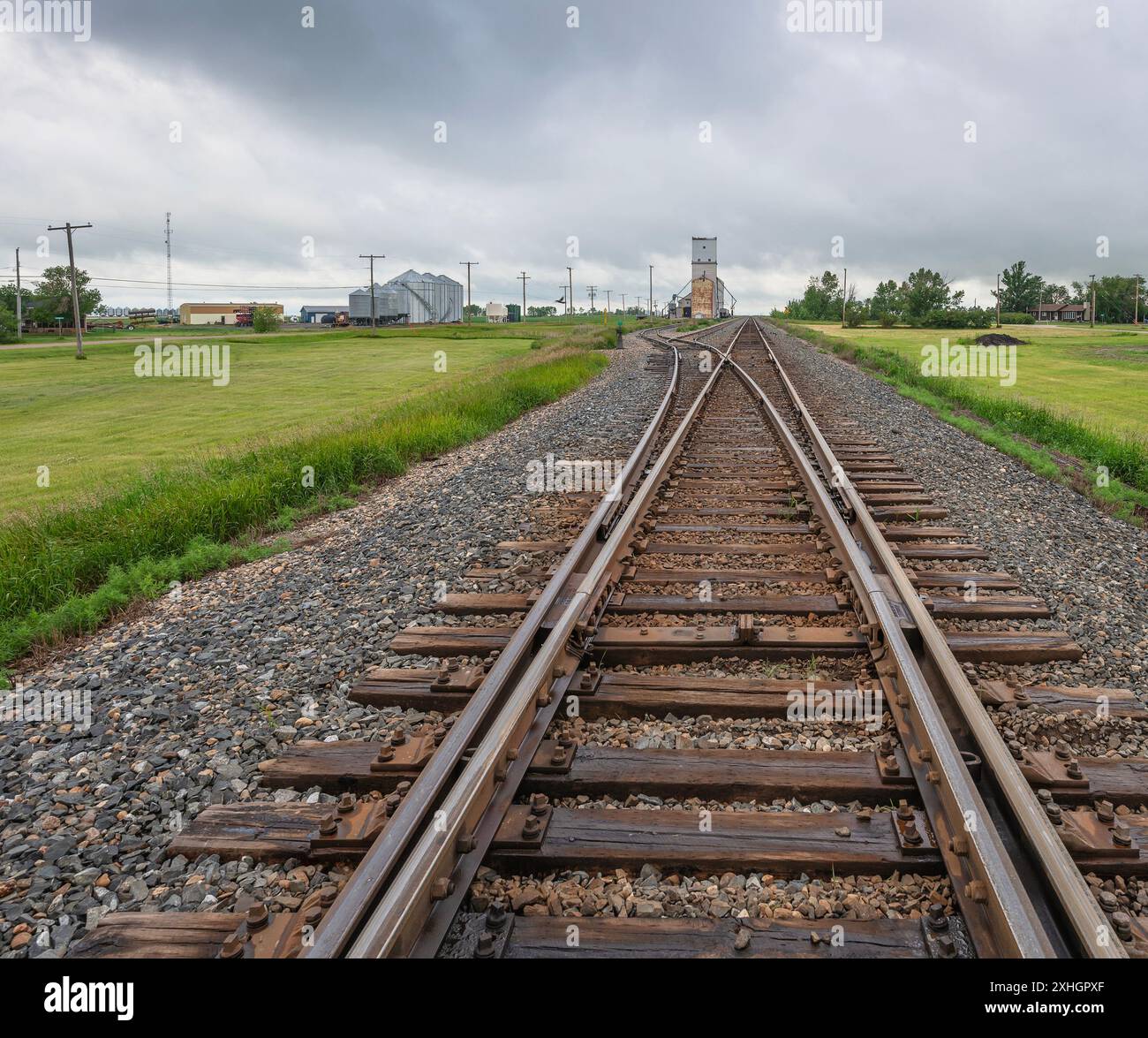 Railroad tracks leading to a grain elevator at the village of Lang ...