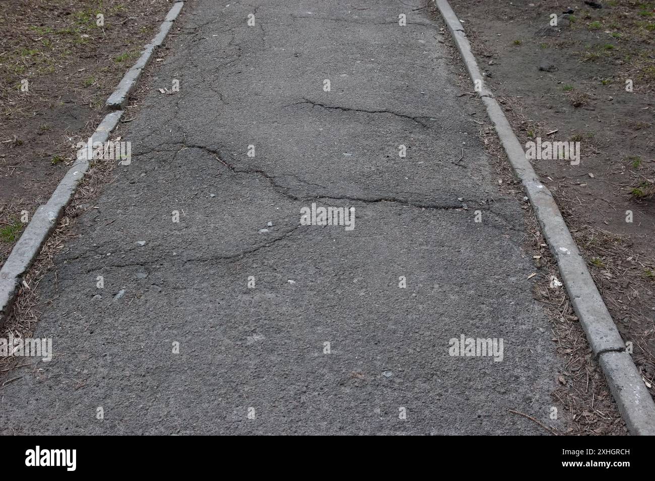 an old cracked asphalt pathway Stock Photo - Alamy