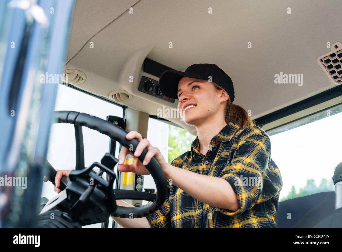 Woman driving tractor farm cabin hi-res stock photography and images ...
