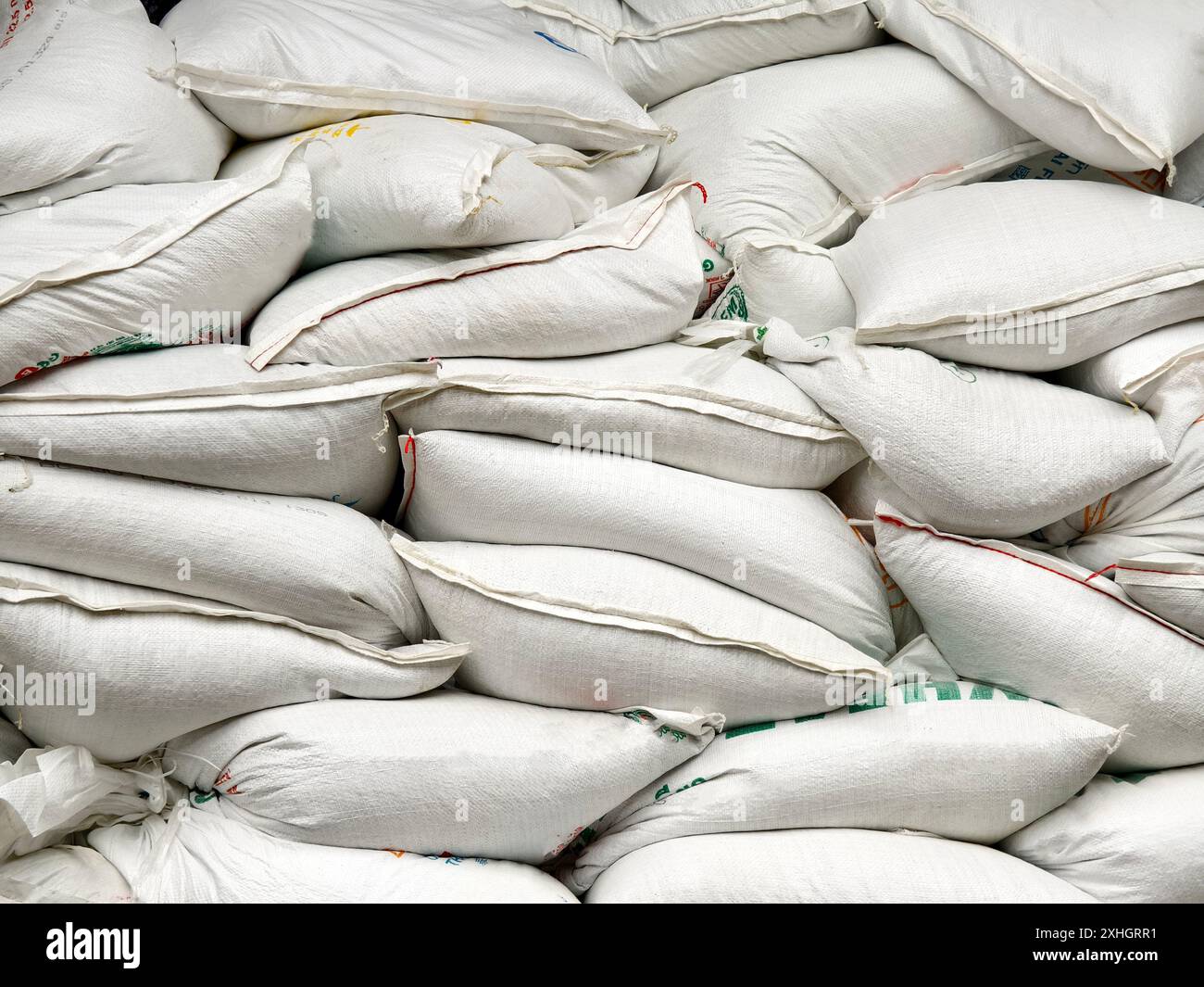 Stacking of big white bags in the modern warehouse Stock Photo - Alamy