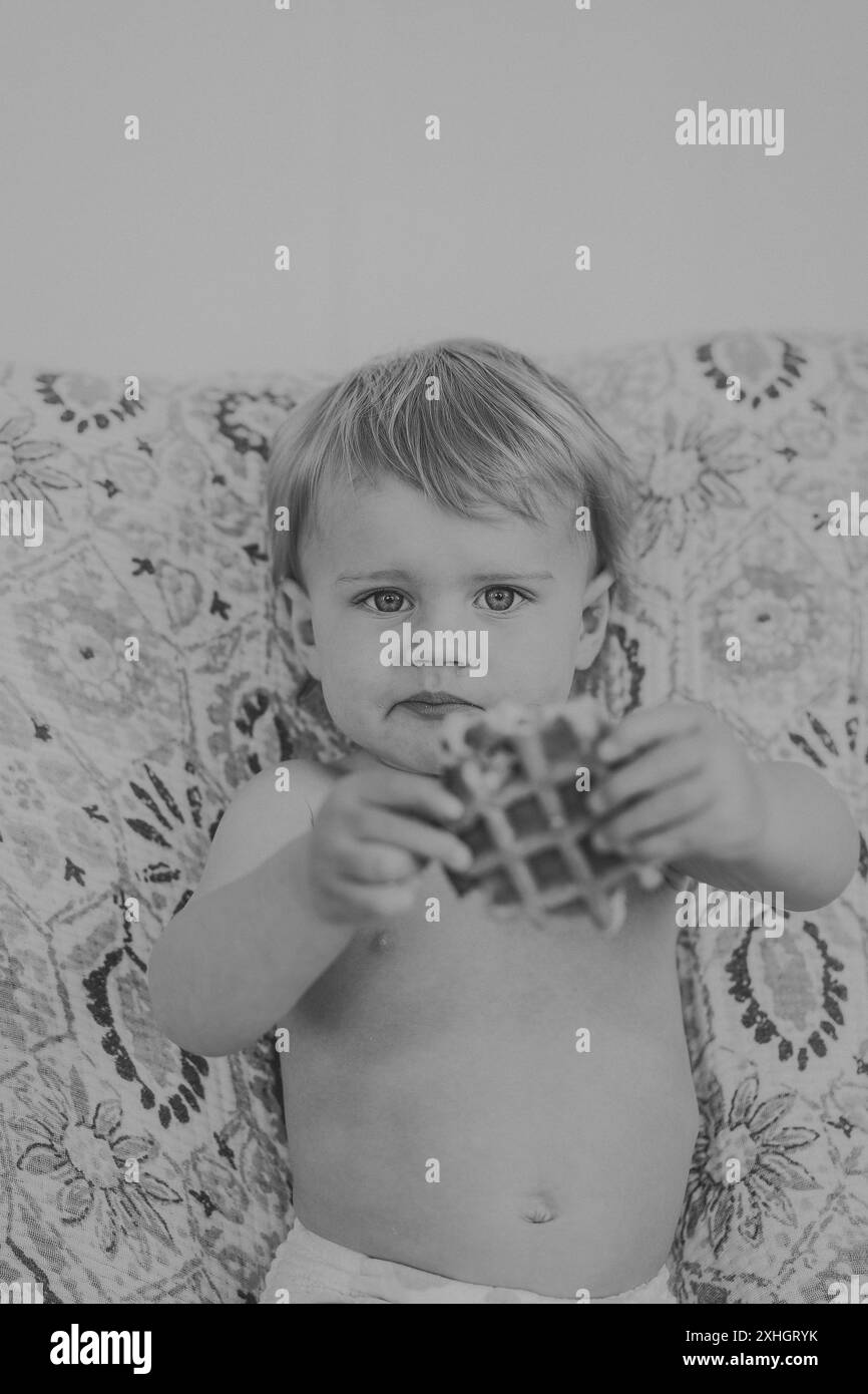 Toddler eating waffle Stock Photo - Alamy