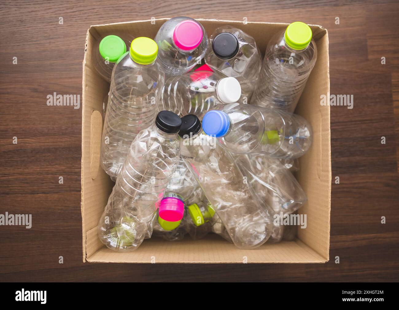 plastic bottles in recycling paper box reuse concept Stock Photo - Alamy
