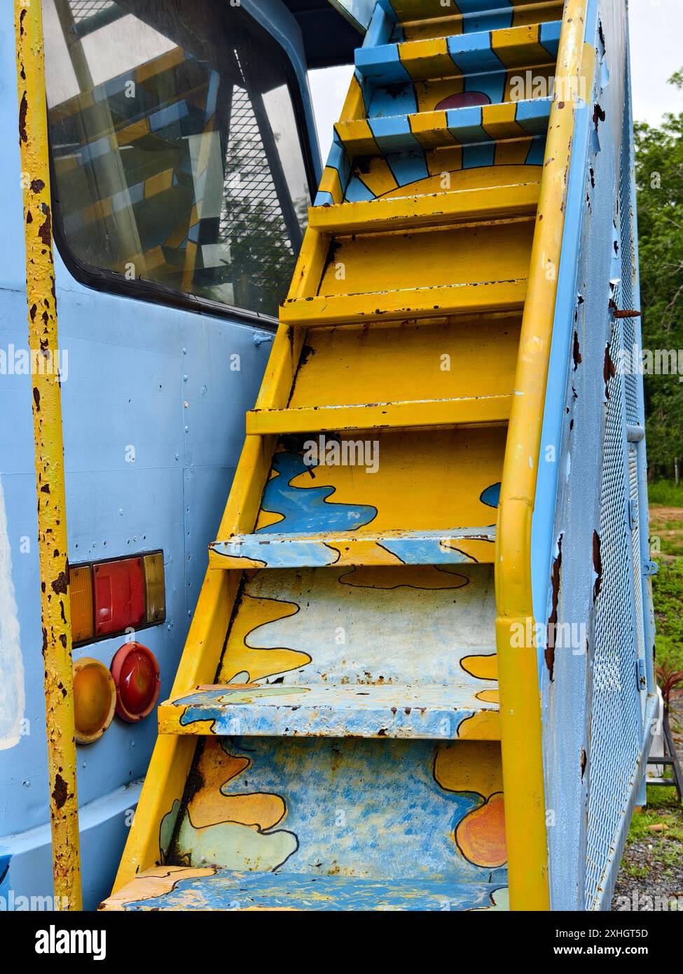 A set of stairs with yellow and blue colors ascending towards on a old ...