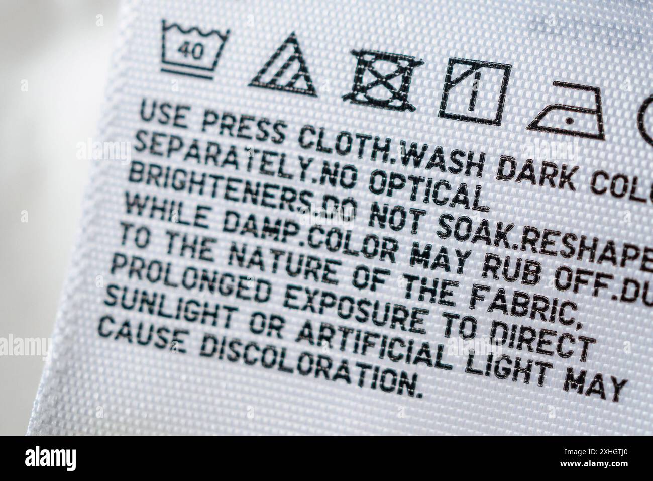 Cloth label tag with laundry care instructions Stock Photo - Alamy
