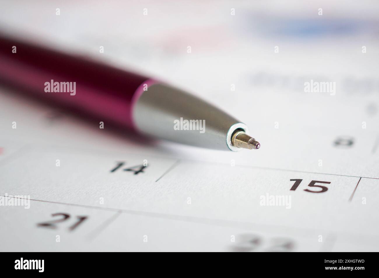 Calendar page with pen point at 15th date Stock Photo - Alamy