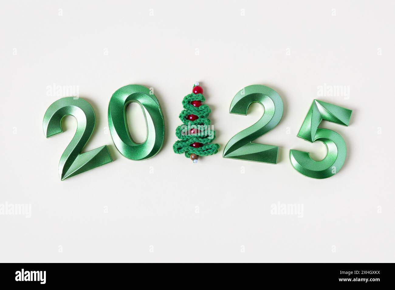 Knitted toy for Christmas tree and green numbers. The symbol of the ...