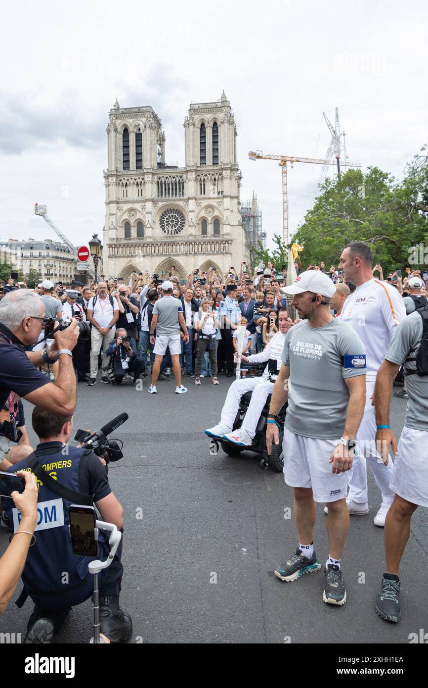 The Olympic torch travels front of Notre Dame of Paris as part of the ...