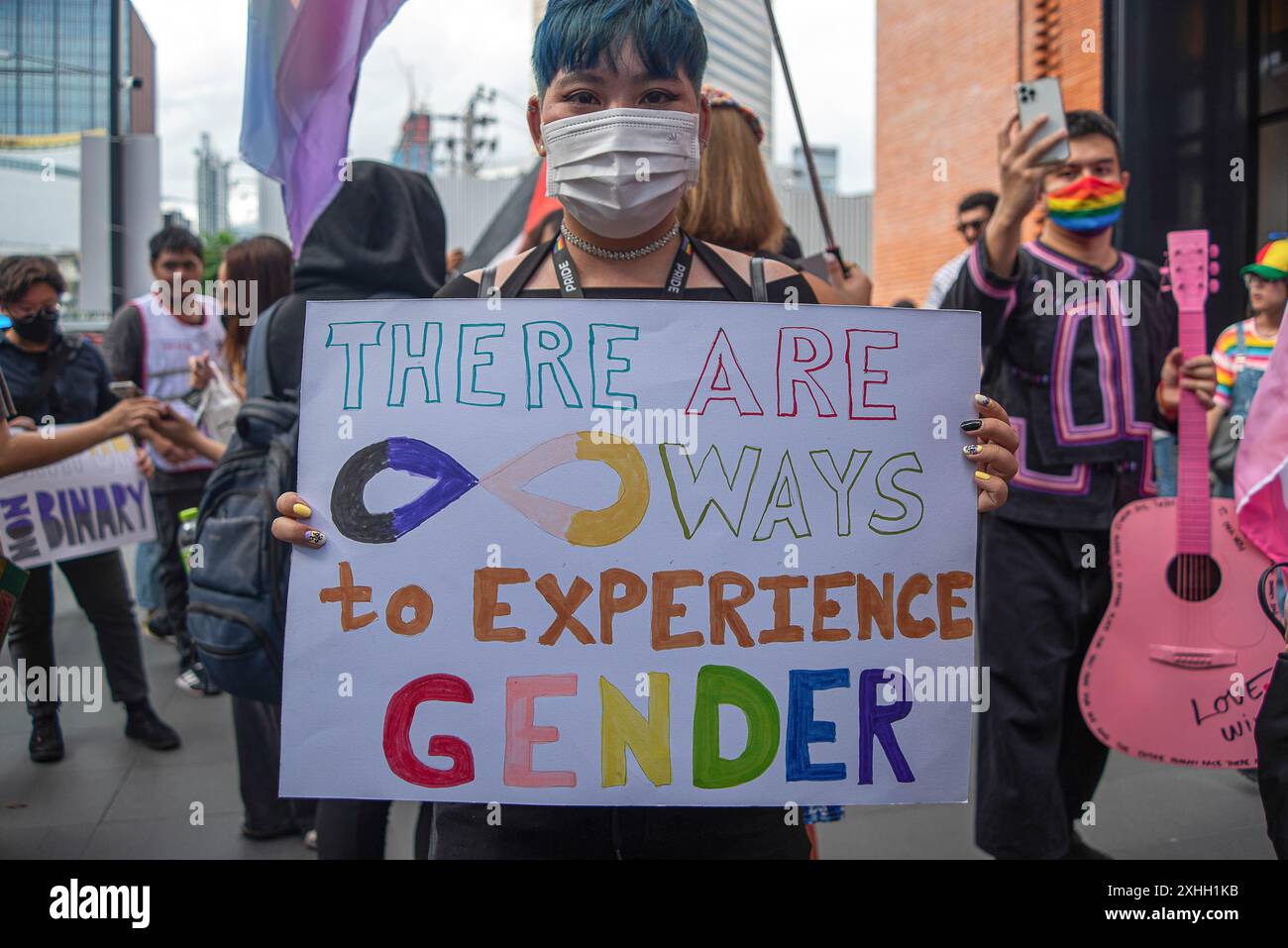 A non-binary supporter holds a placard during the demonstration. The ...