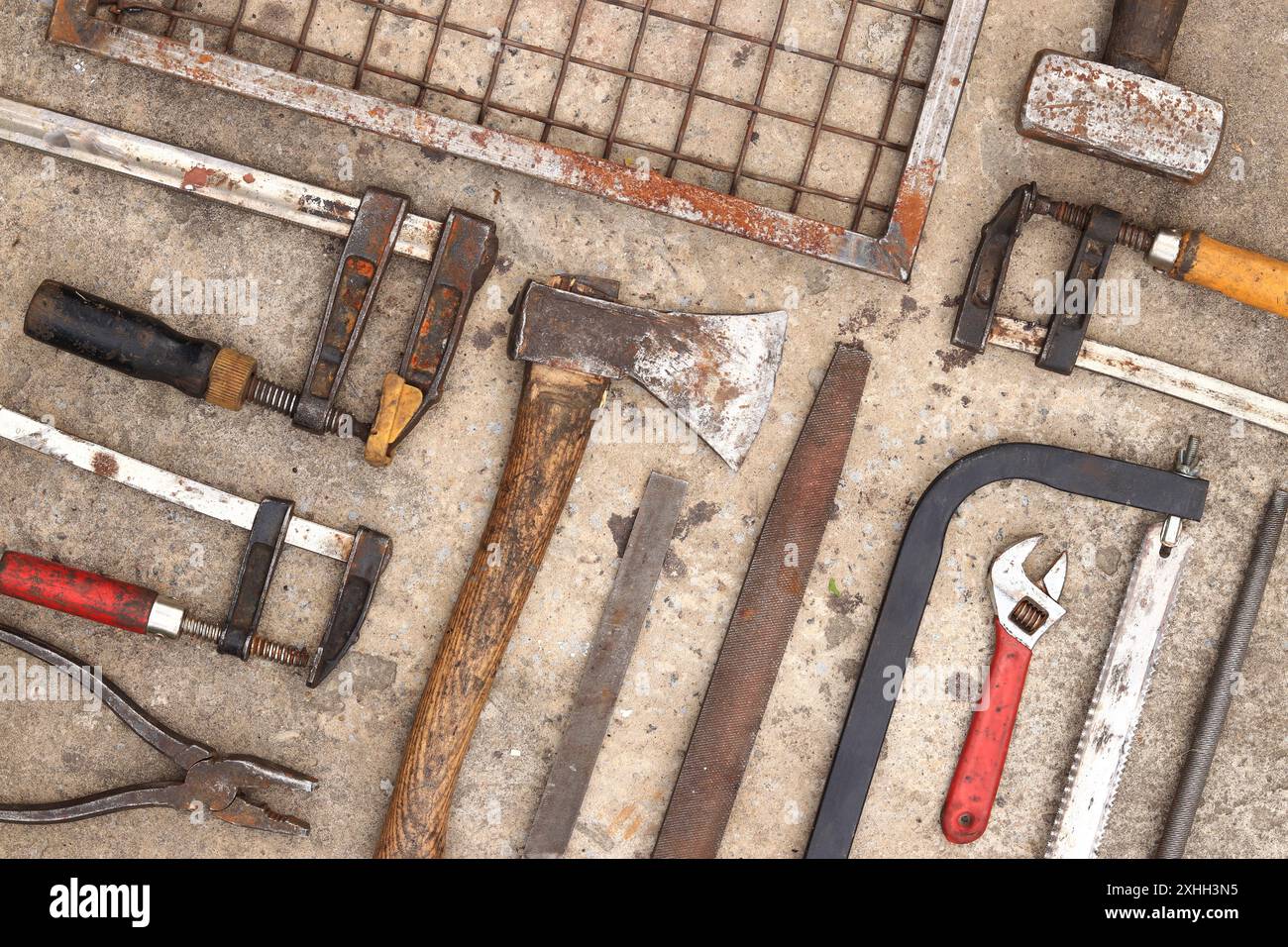 Old construction tools laid out on a concrete background, top view ...