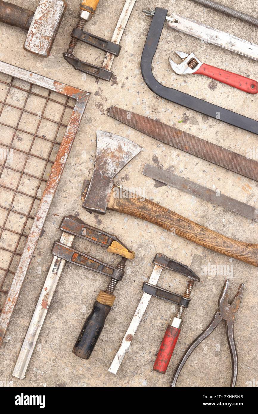 Old construction tools laid out on a concrete background, top view ...